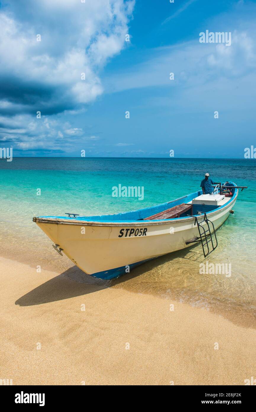 Little motorboat in the turquoise waters of Banana beach, Unesco ...