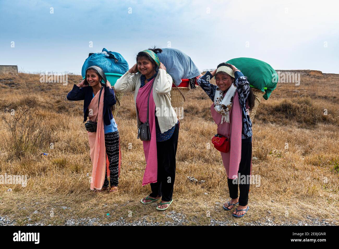 Khasi women carrying the laundry to a creek in a traditional basket ...