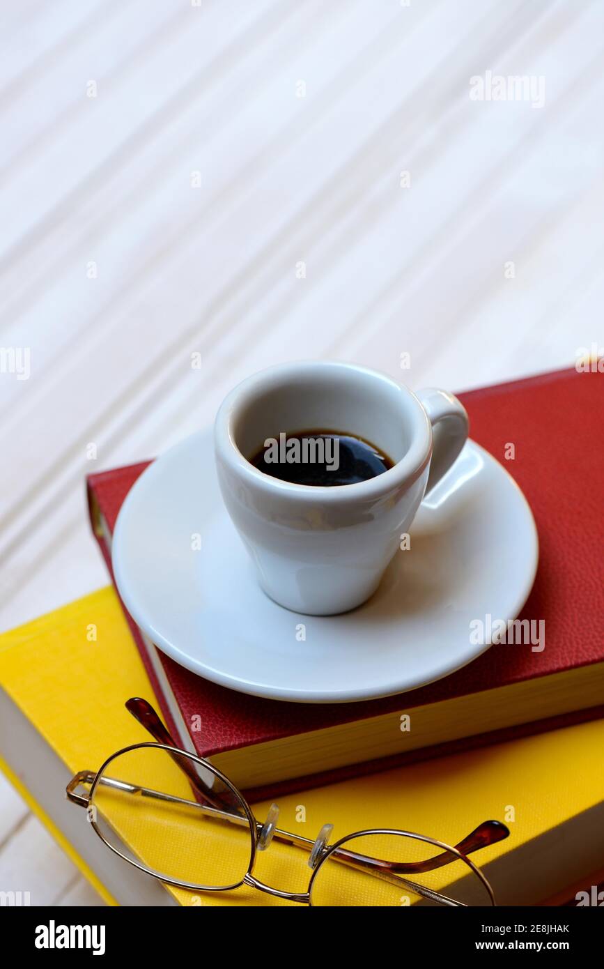 Cup on pile books hi-res stock photography and images - Alamy