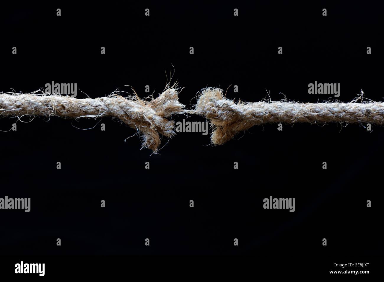 Defective jute rope, on a silk thread, torn, frayed Stock Photo - Alamy