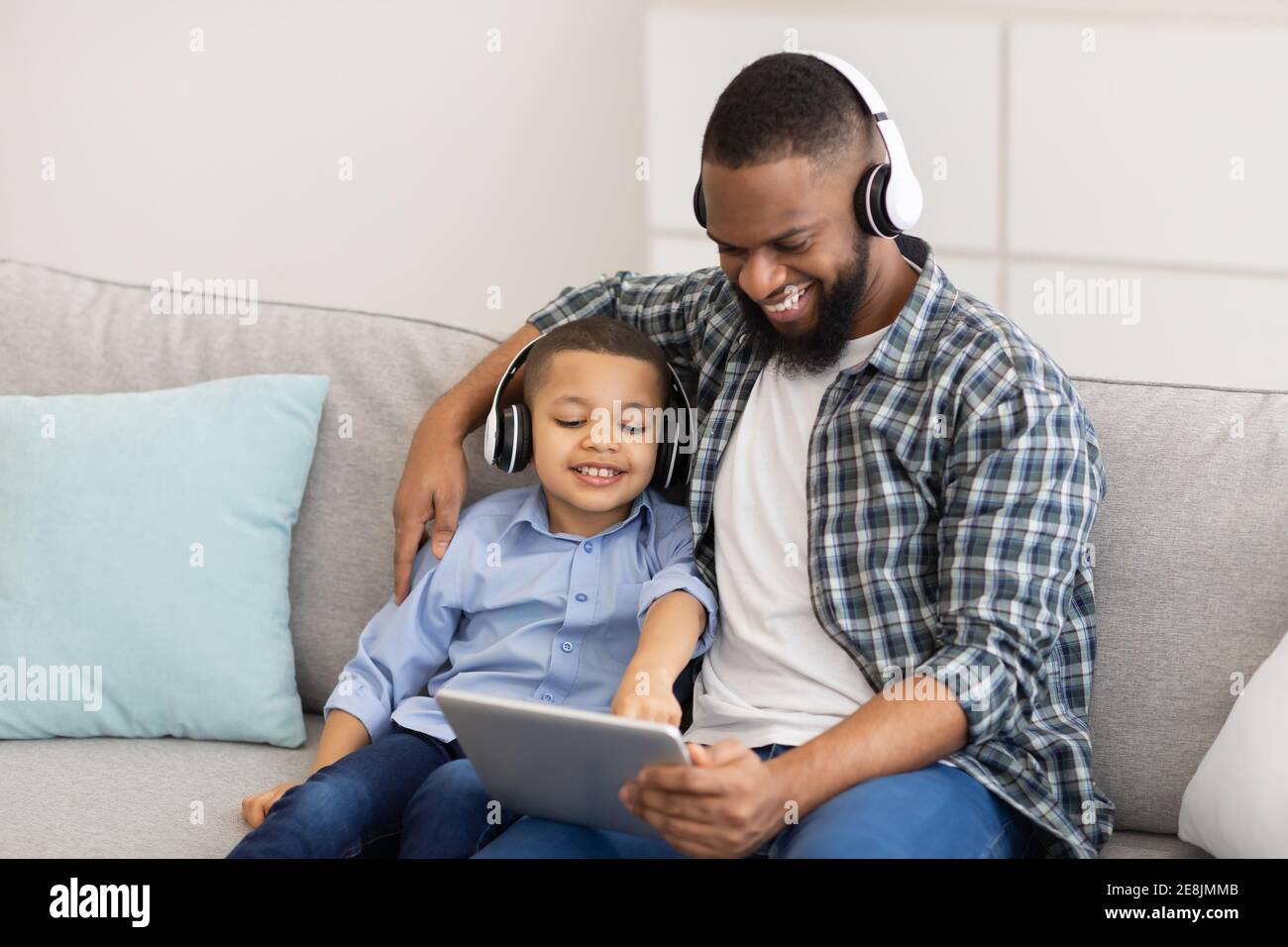 Black Father And Son Using Digital Tablet Computer At Home Stock Photo ...