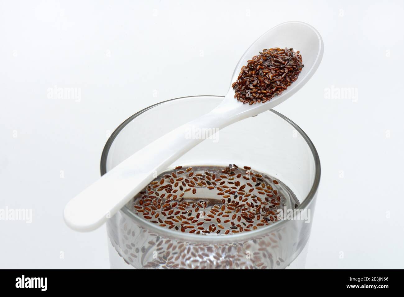 Glass of water and spoon with psyllium, sand plantain, Plantago ...