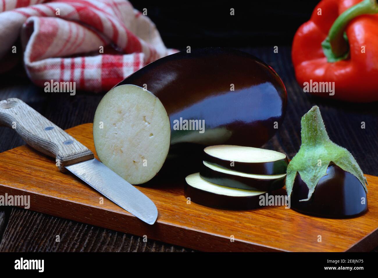 Truncated Egg plant ( Solanum melongena) with knife and paprika Stock ...