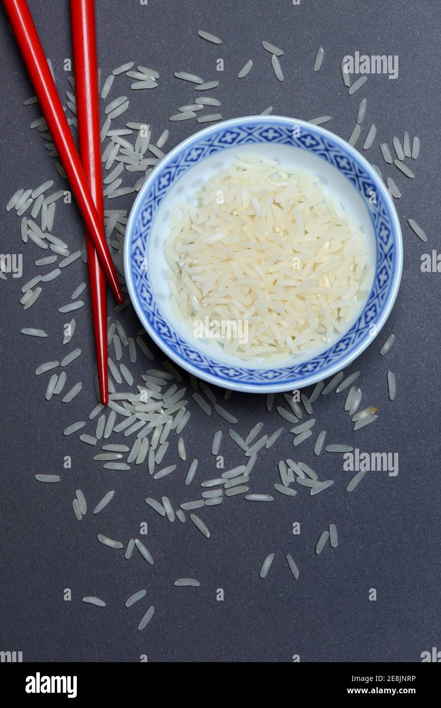 Rice grains in husk and chopsticks, basmati rice, Oryza sativa ...
