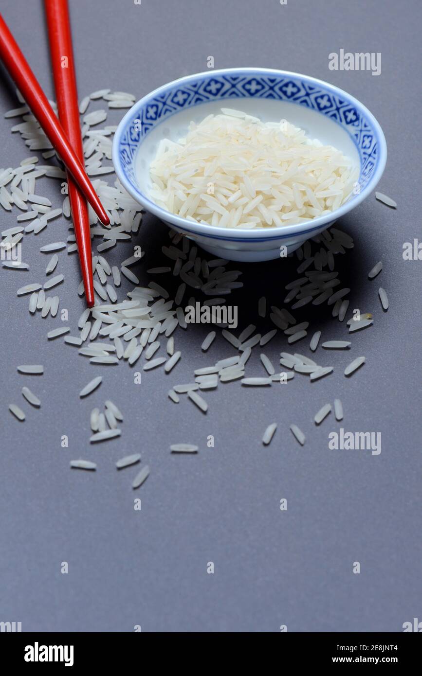 Rice grains in husk and chopsticks, basmati rice, Oryza sativa ...