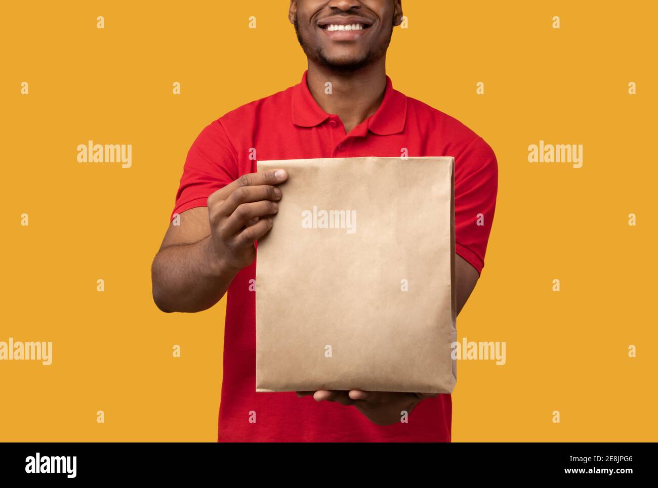 Black delivery man holding package hi-res stock photography and images ...