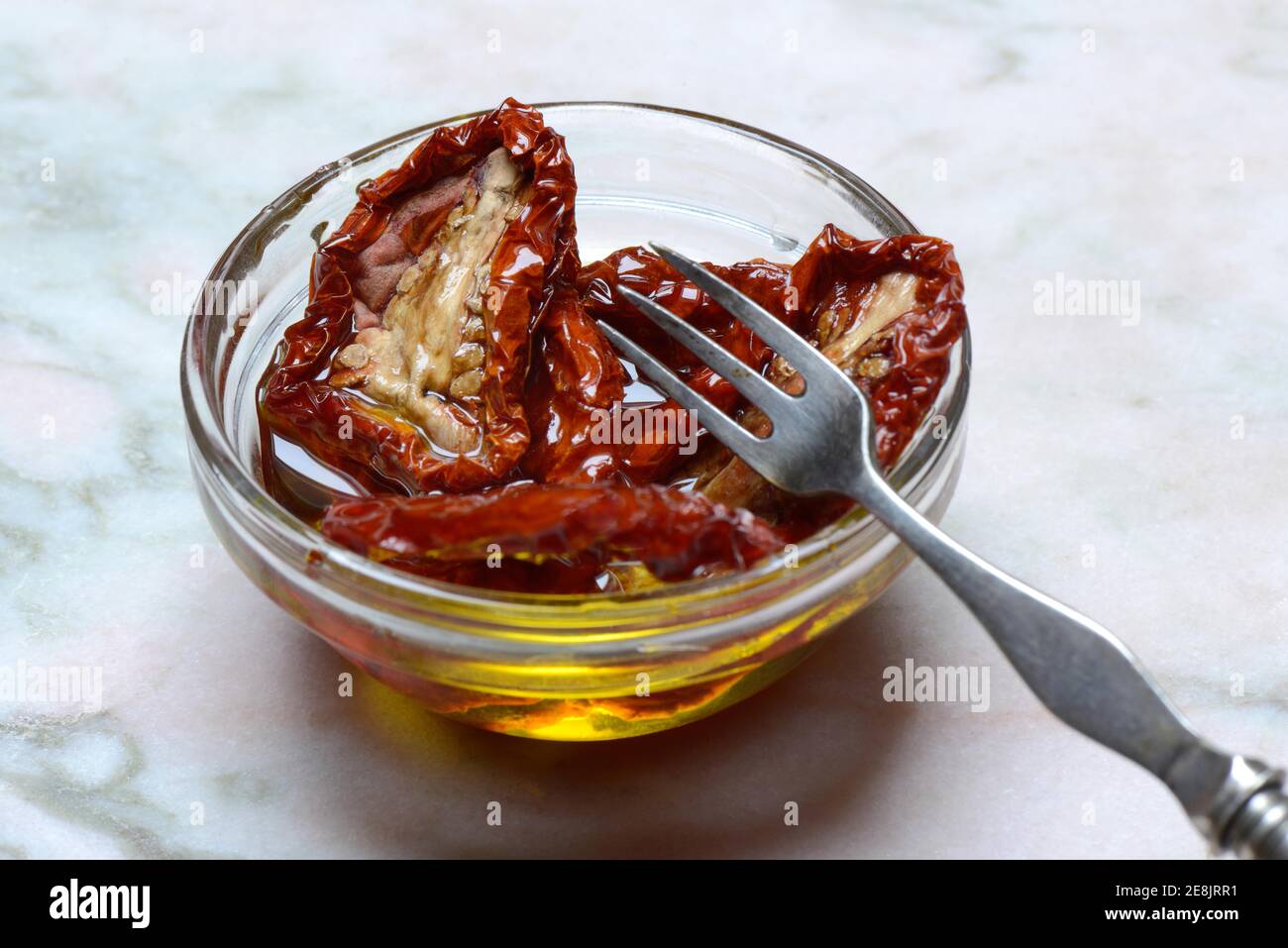 Dried tomatoes in olive oil, Solanum lycopersicum Stock Photo - Alamy