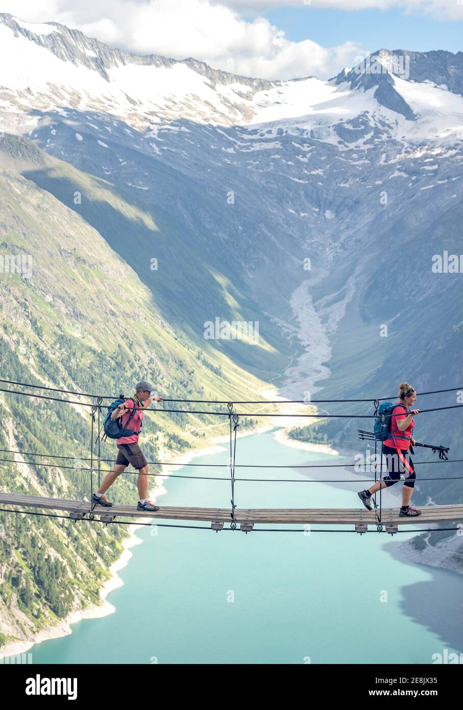 Olpererhutte, Austria - Aug 7, 2020: Two female trekker walk on swing ...