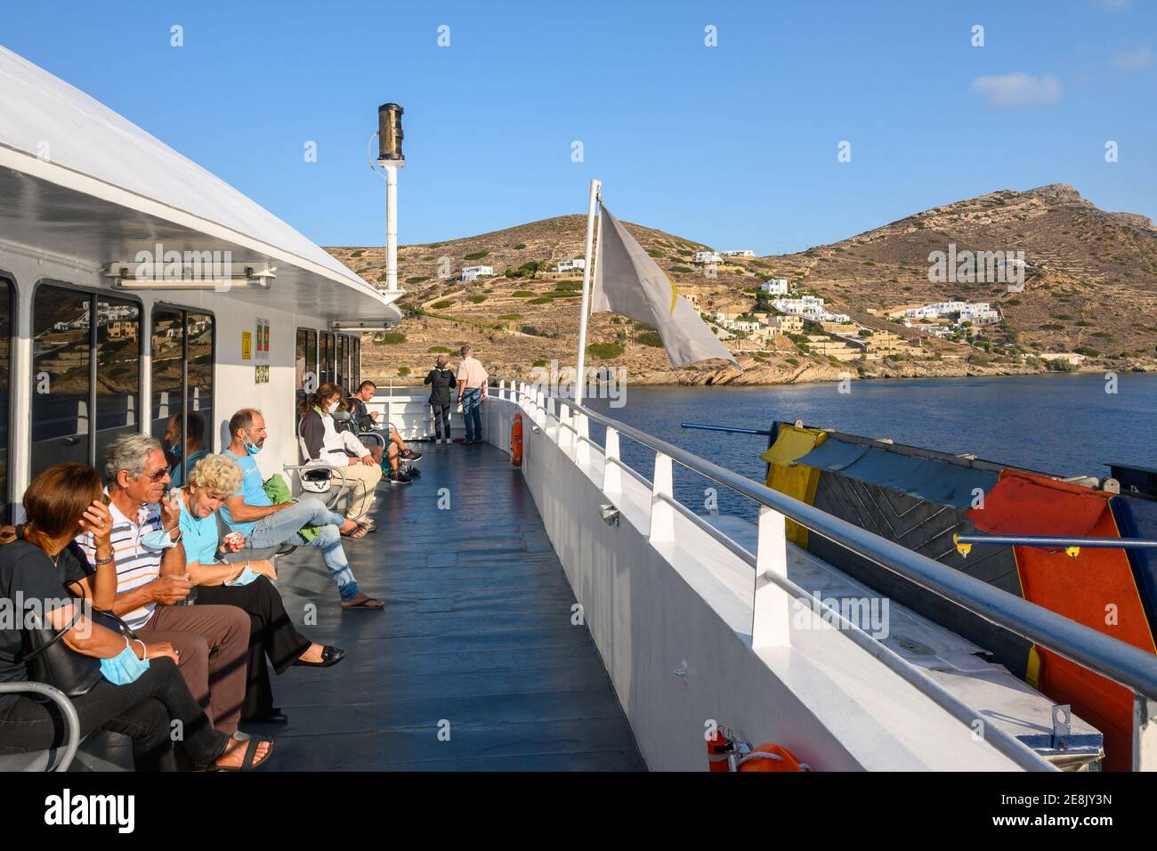 Ios, Greece - September 23, 2020: Tourist sitting on bench of ferry ...