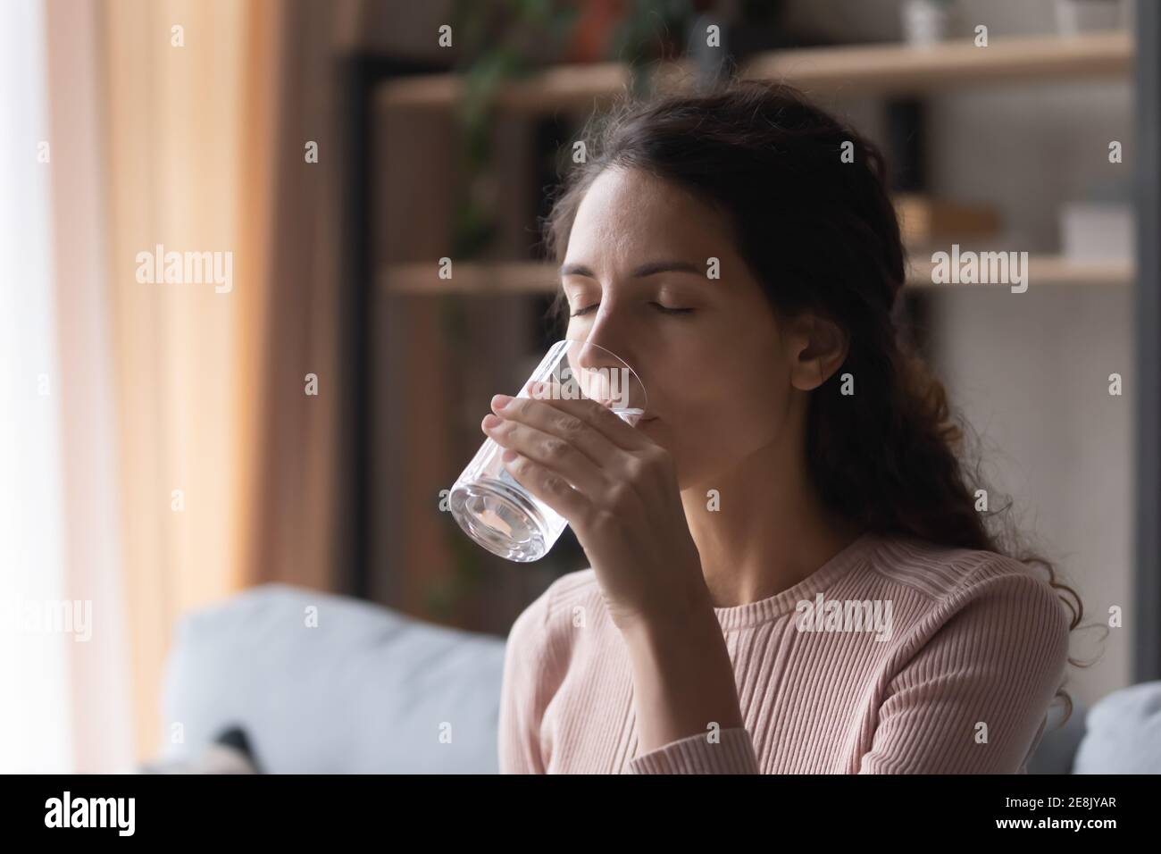 Happy young woman drinking glass of fresh pure mineral water Stock ...
