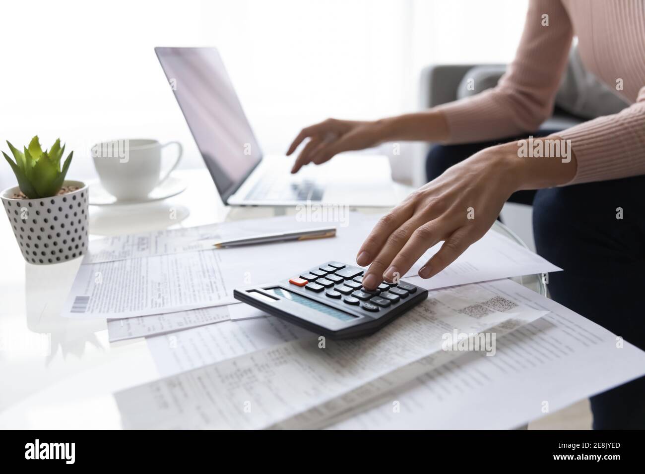 Close up young woman calculating expenses using computer app Stock ...