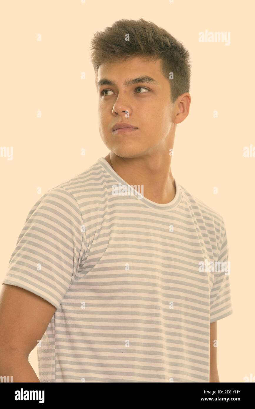 Studio shot of thoughtful young handsome man looking back Stock Photo ...