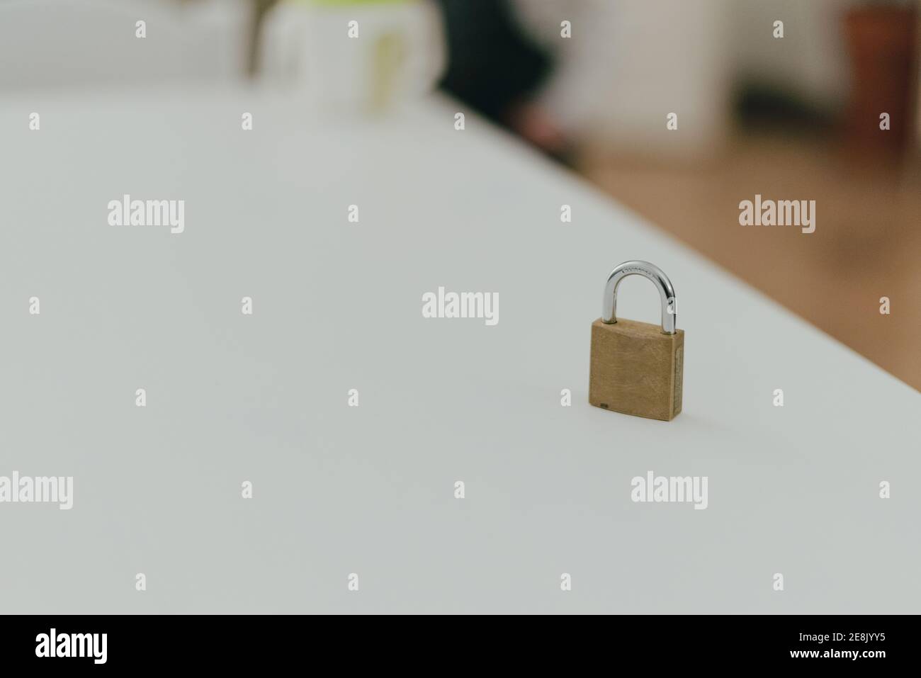 A closeup shot of a small lock on a white surface Stock Photo - Alamy