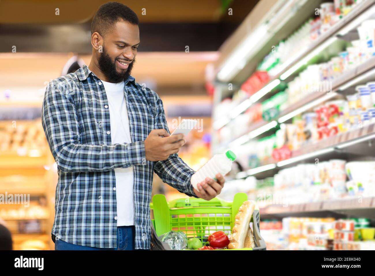 Guy Scanning Product Via Phone Doing Grocery Shopping In Supermarket ...