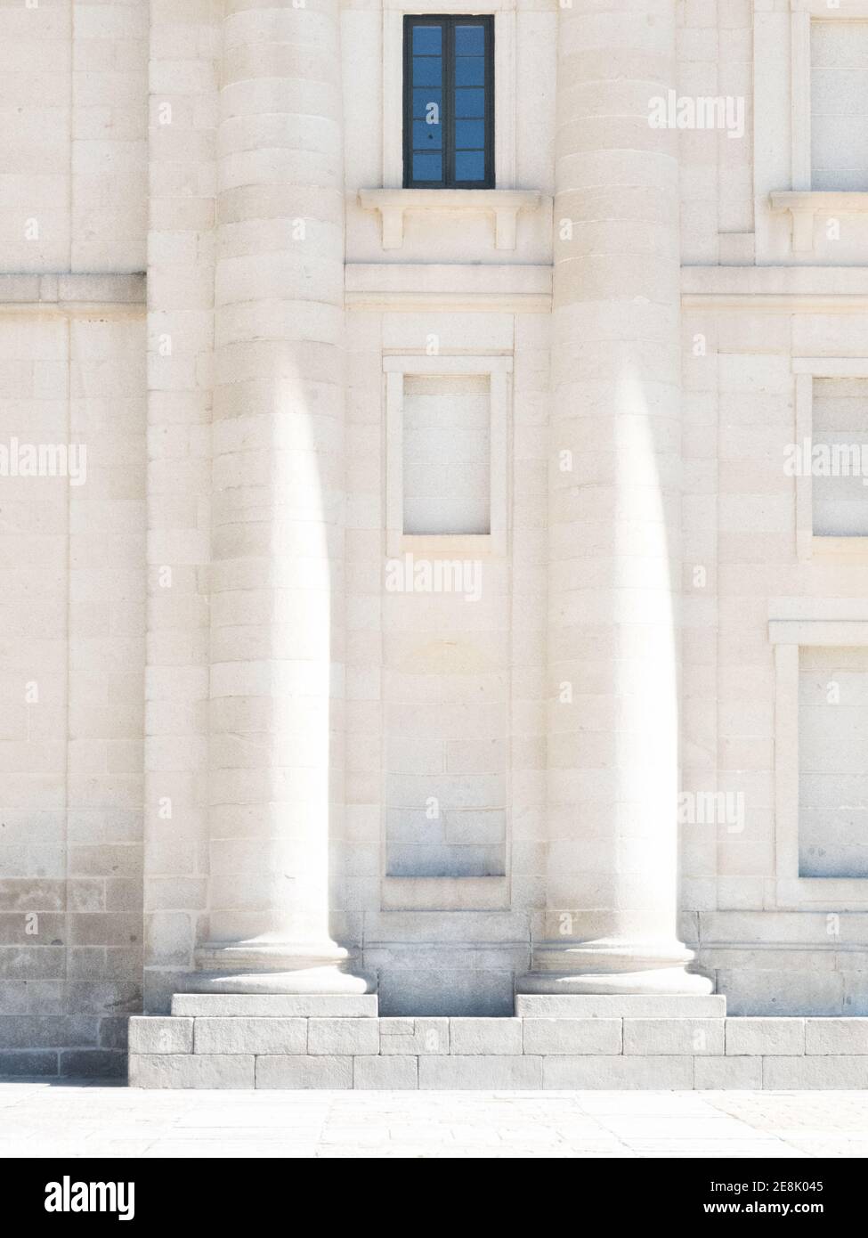A vertical shot of a tall white building with columns Stock Photo - Alamy