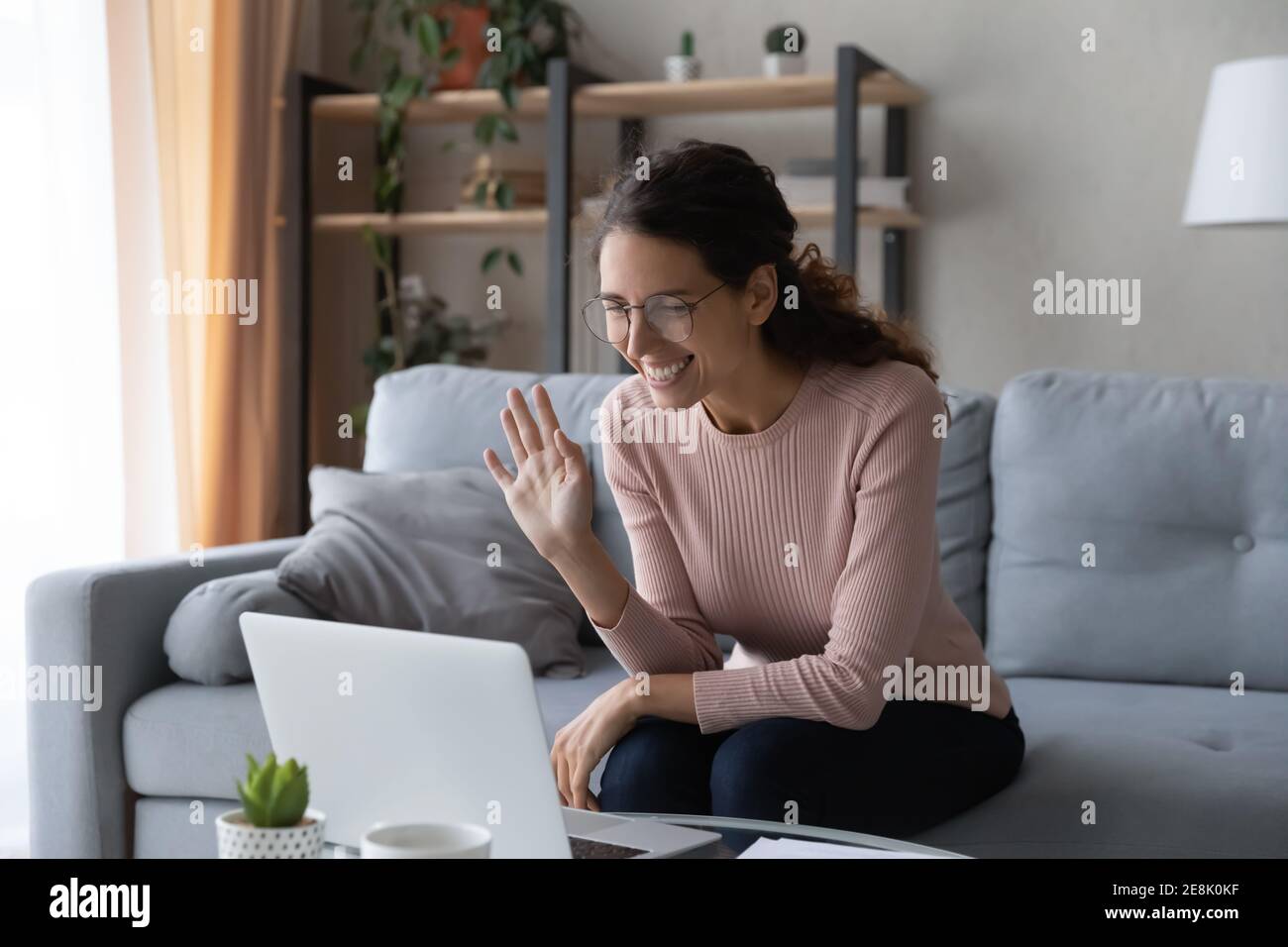 Happy young woman starting online video call conversation Stock Photo ...