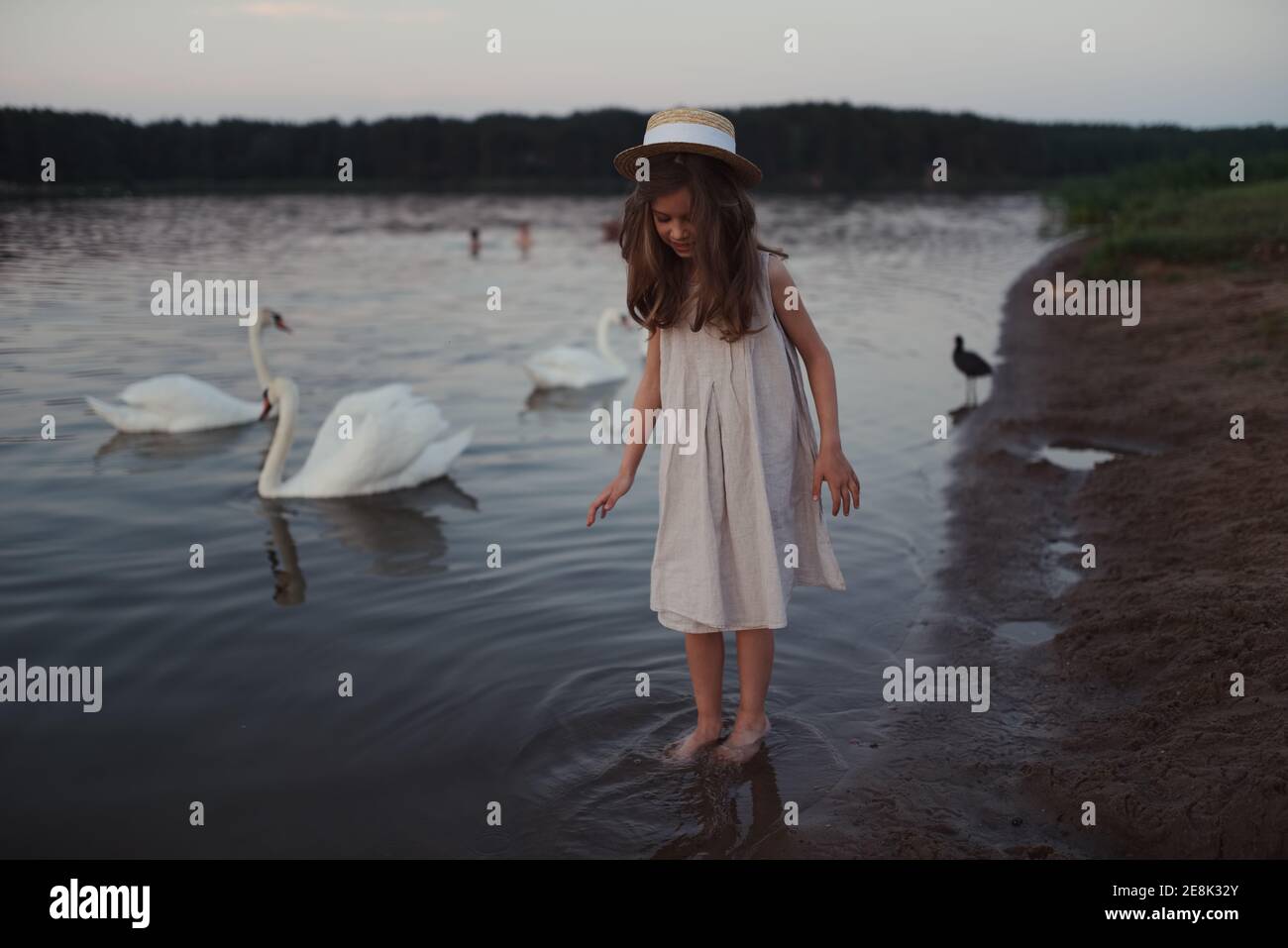 little cute girl with long hair on the lake Stock Photo - Alamy