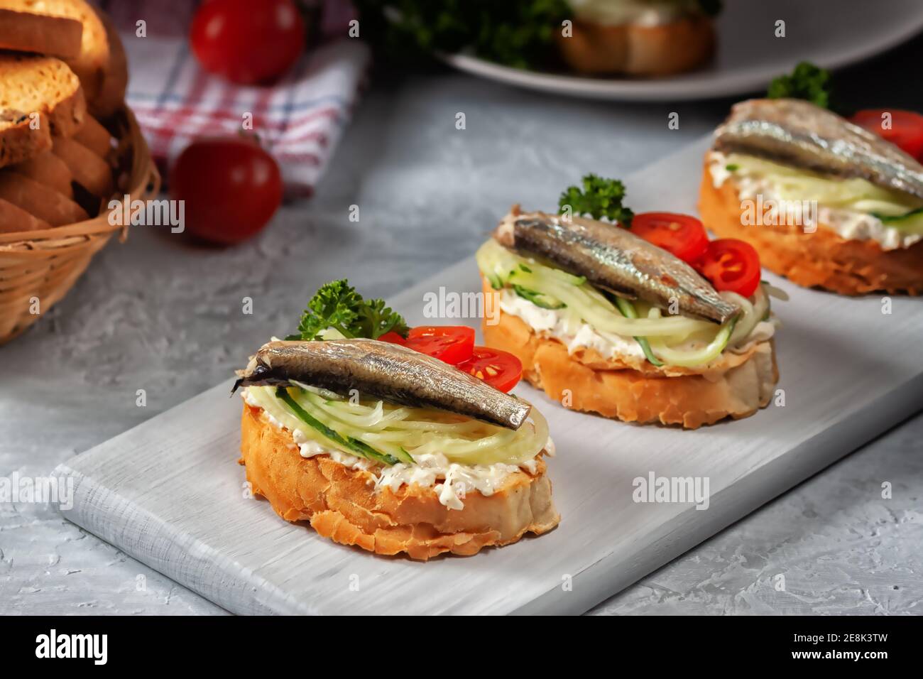 Smoked sprat sandwich - fish, fresh cucumber and tomato. Sprat ...
