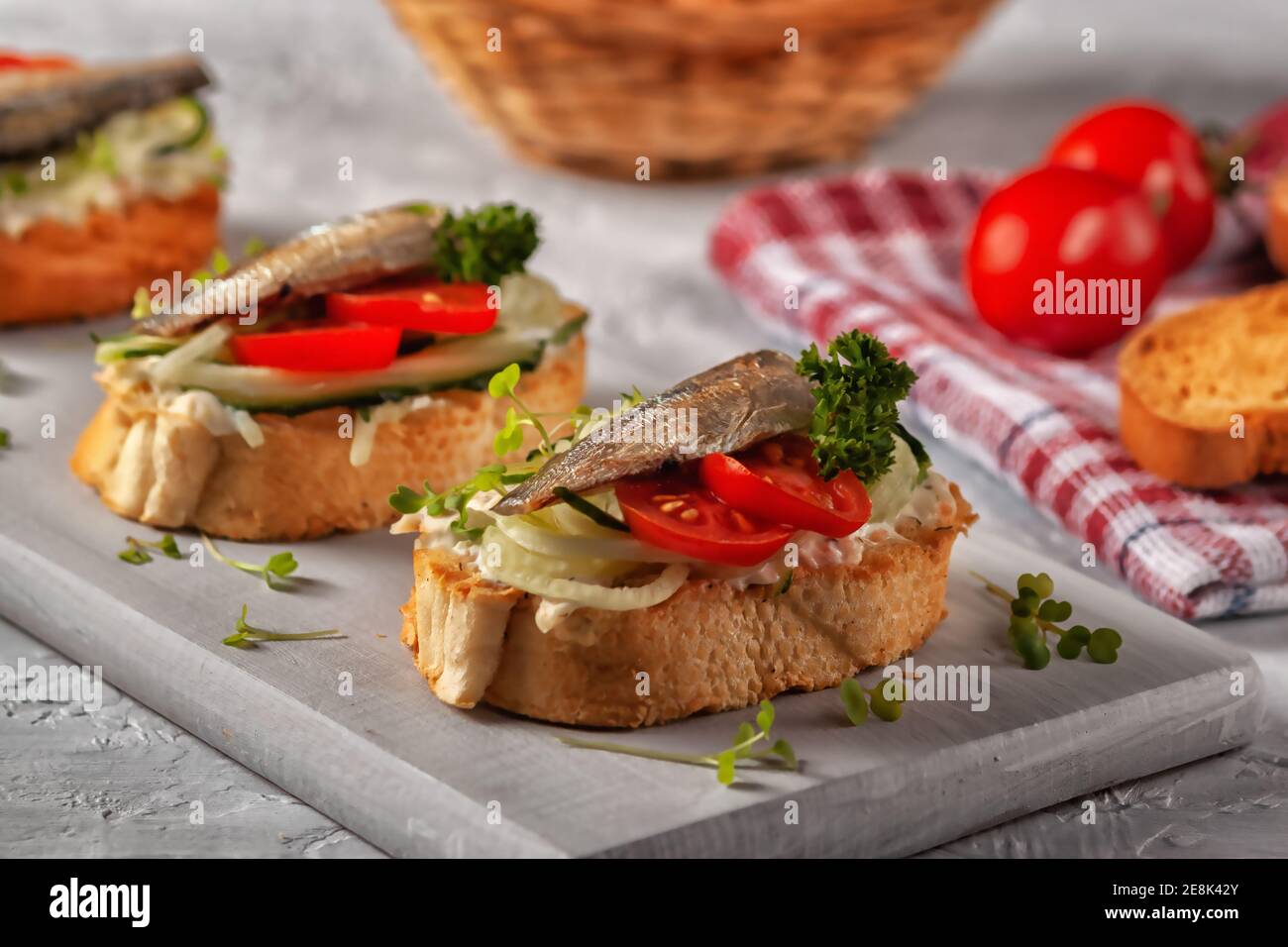 Smoked sprat sandwich - fish, fresh cucumber and tomato. Sprat ...
