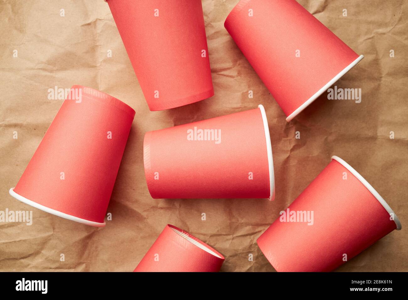 pile of disposable red paper cups on paper background. eco friendly ...