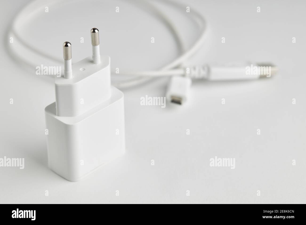 white usb charge or power adapter with usb wire at background. charging ...