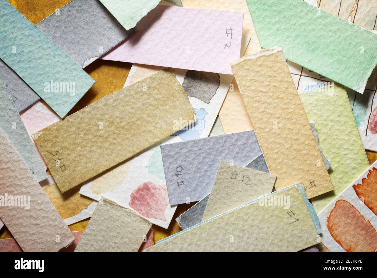 Watercolor test cards on a painted paper Stock Photo - Alamy