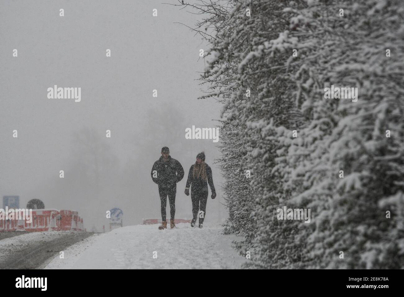 two people walking in the snow Stock Photo - Alamy
