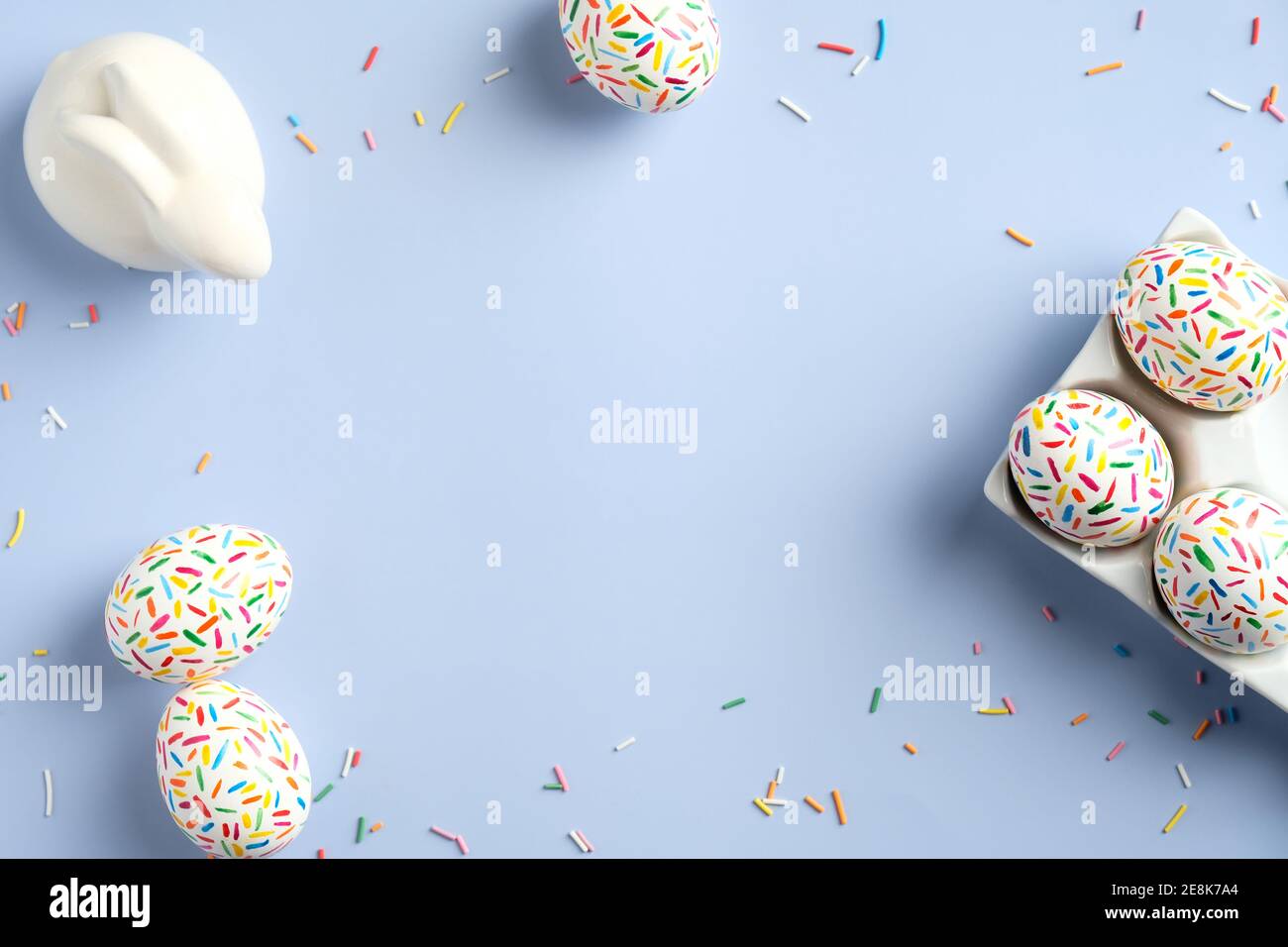 Cute Easter eggs and bunny on pastel blue background. Easter banner mockup. Flat lay, top view ...