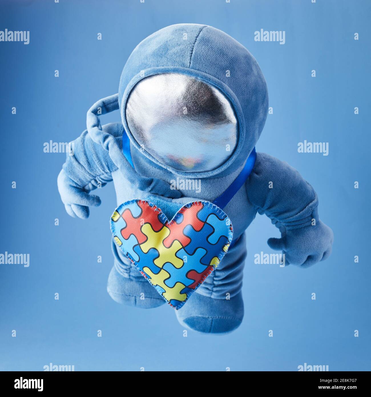 World Autism awareness day background. Blue plush astronaut toy with ...