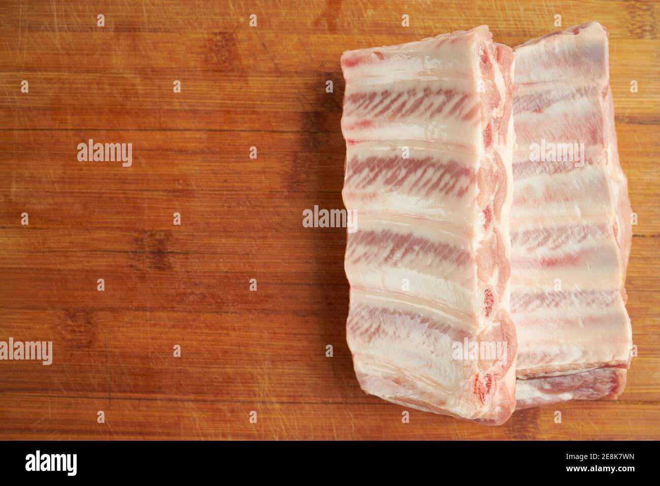 fresh raw ribs on a wooden board with copy space. top view Stock Photo ...
