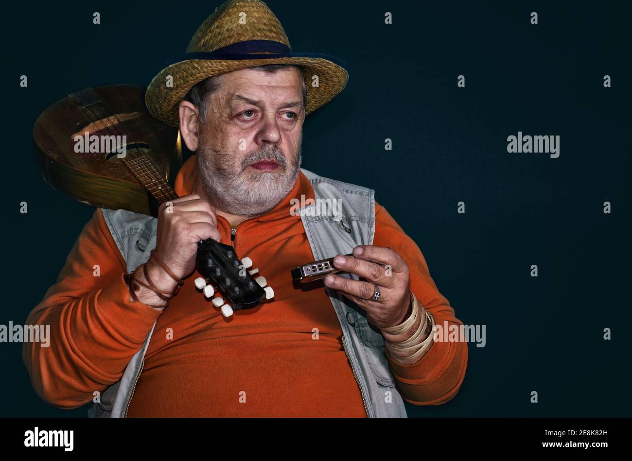 Nice low key portrait of Caucasian senior musician with mandolin and ...