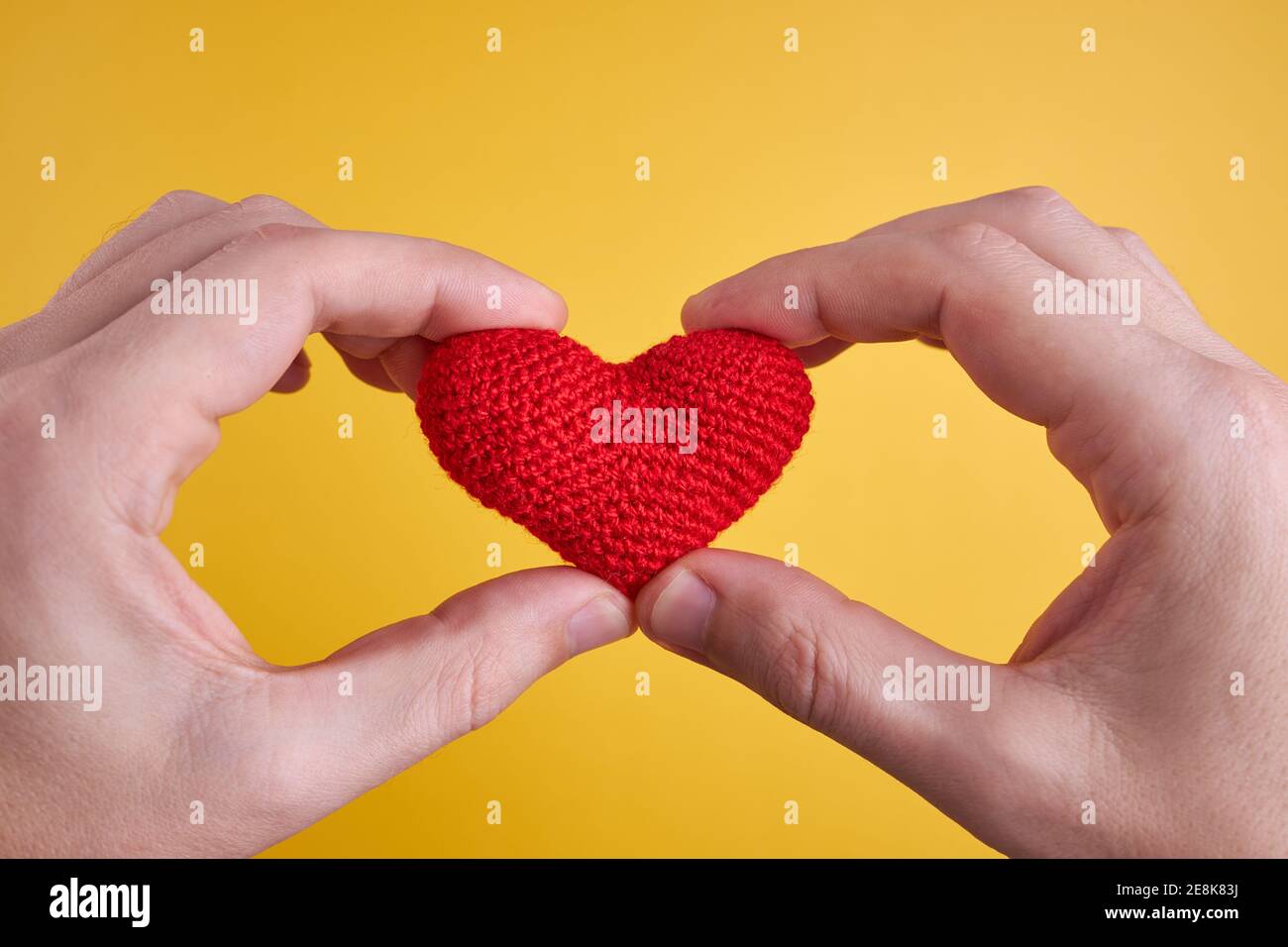 Heart Symbol At Persons Hand Isolated On Yellow Background Love And
