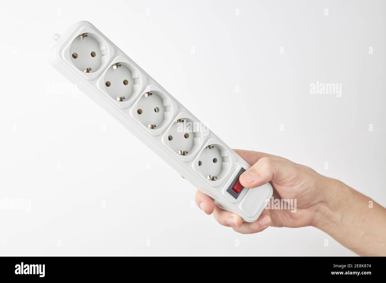 person holds empty white power cord strip. outer space. isolated on ...