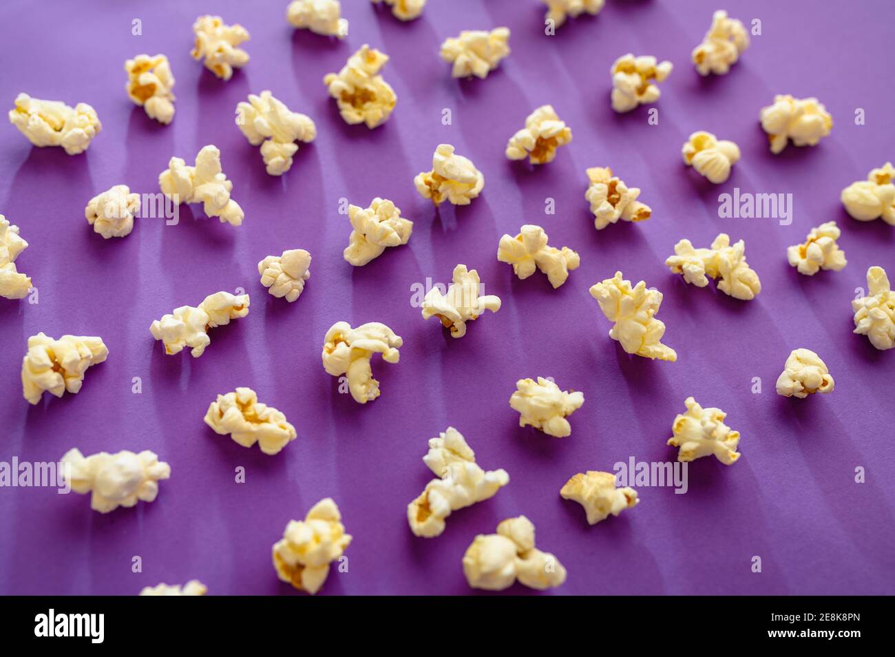 Popcorn pattern isolated on purple background Stock Photo - Alamy