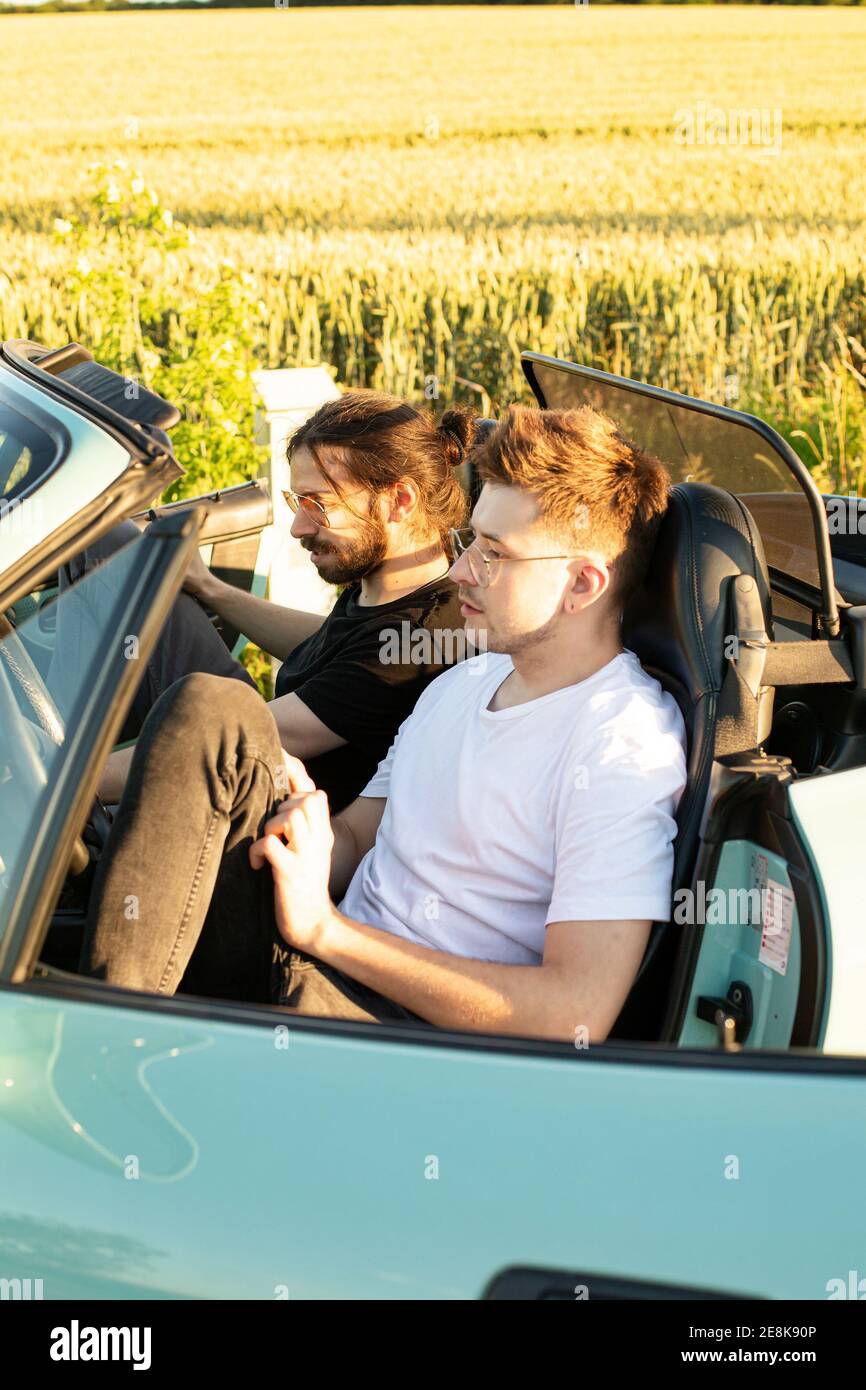 Young white models men sitting in the car Stock Photo - Alamy