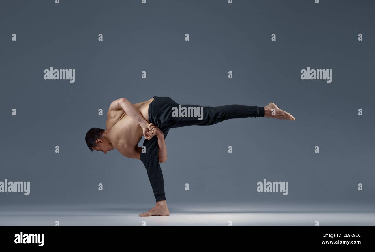 Yoga keeps balanc in a difficult pose on one leg Stock Photo - Alamy