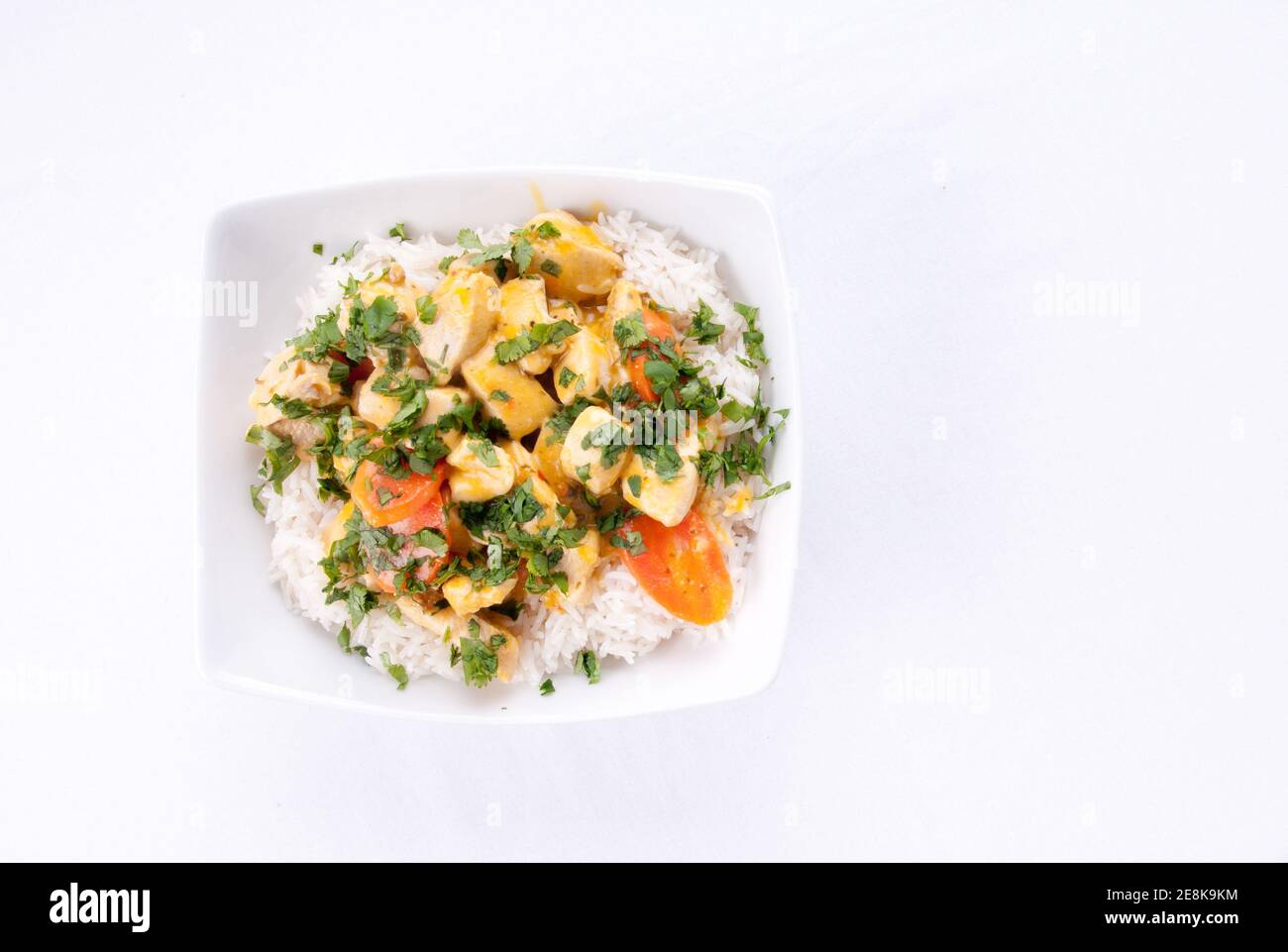 Thai coconut and mango curry with diced chicken and sliced carrots over ...
