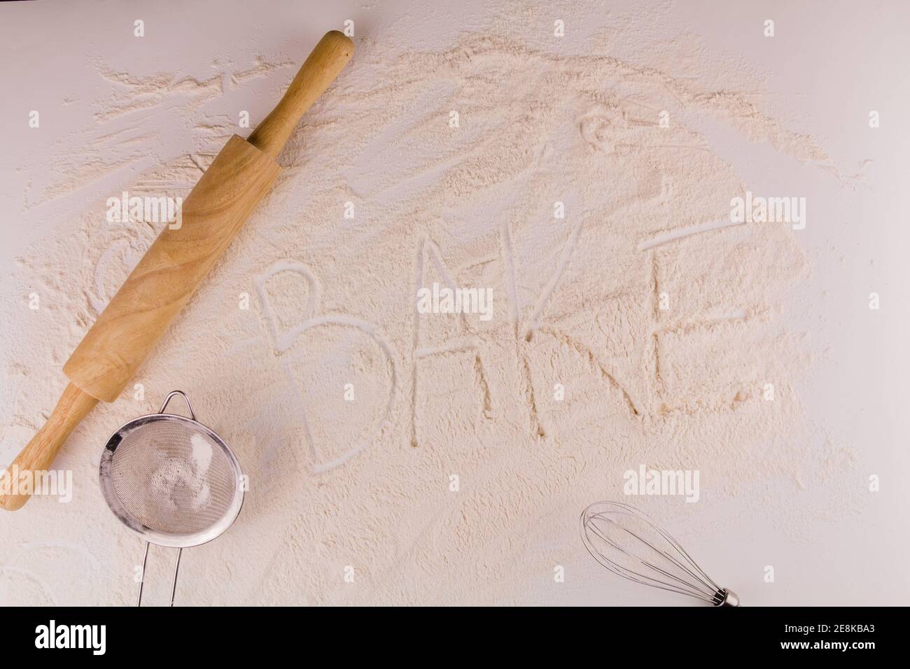 a word baked goods on white background flour with rolling pin on ...