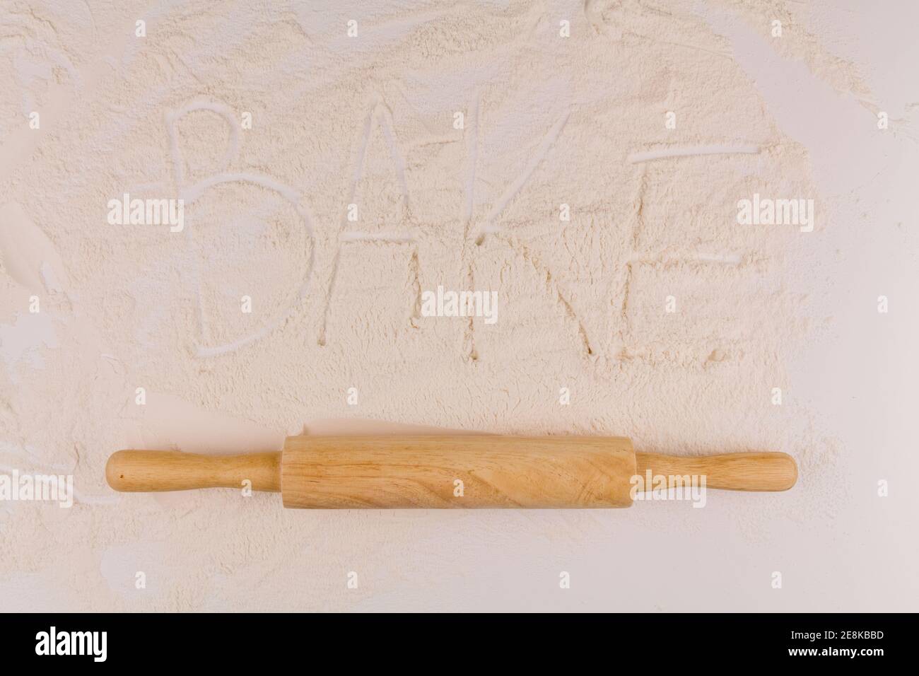 a word baked goods on white background flour with rolling pin on ...