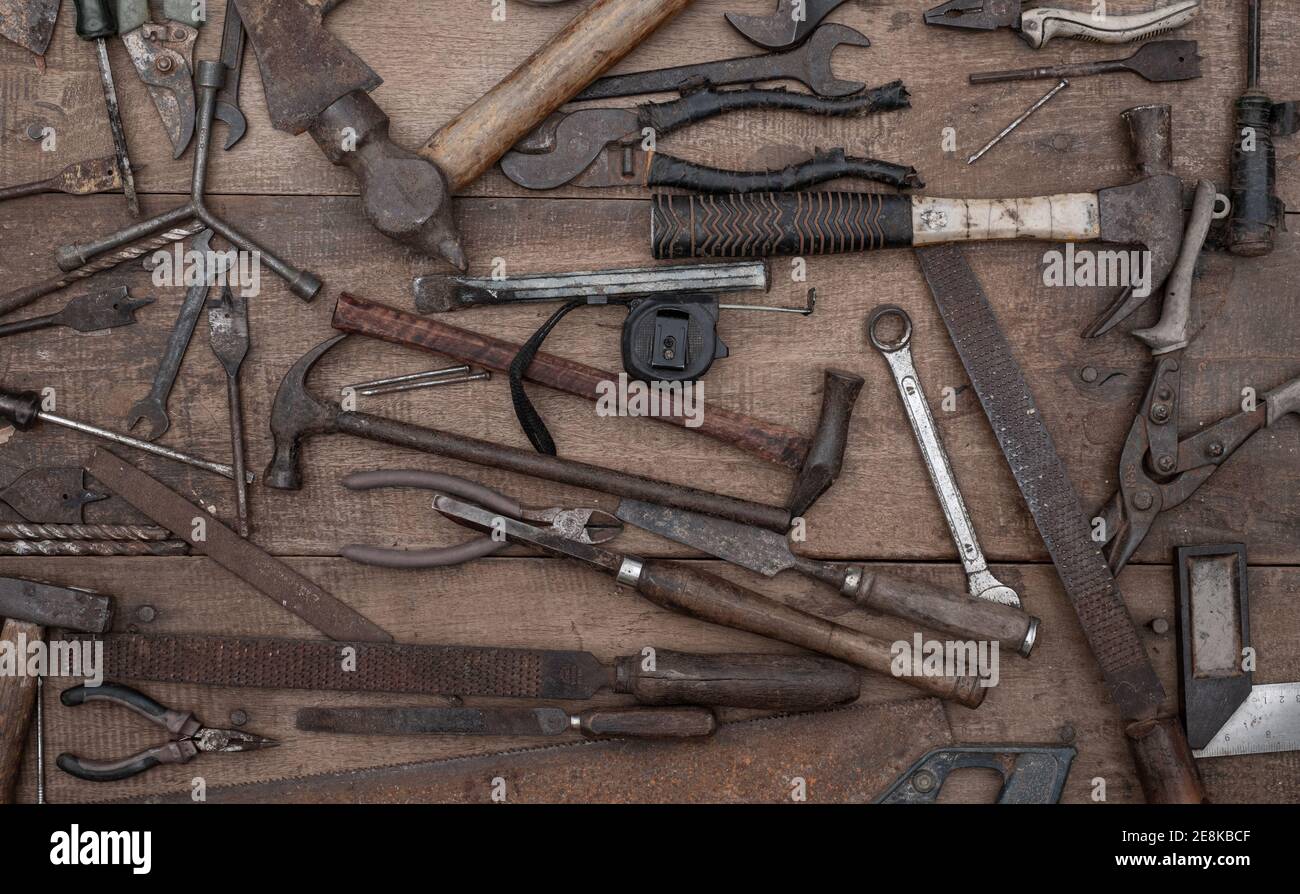 Collection of antique woodworking handtools on a rough workbench old ...