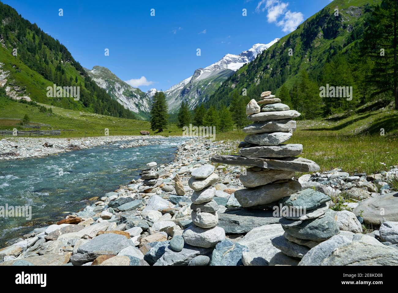 Valley in the alps with river stack of stones in the foreground Stock ...