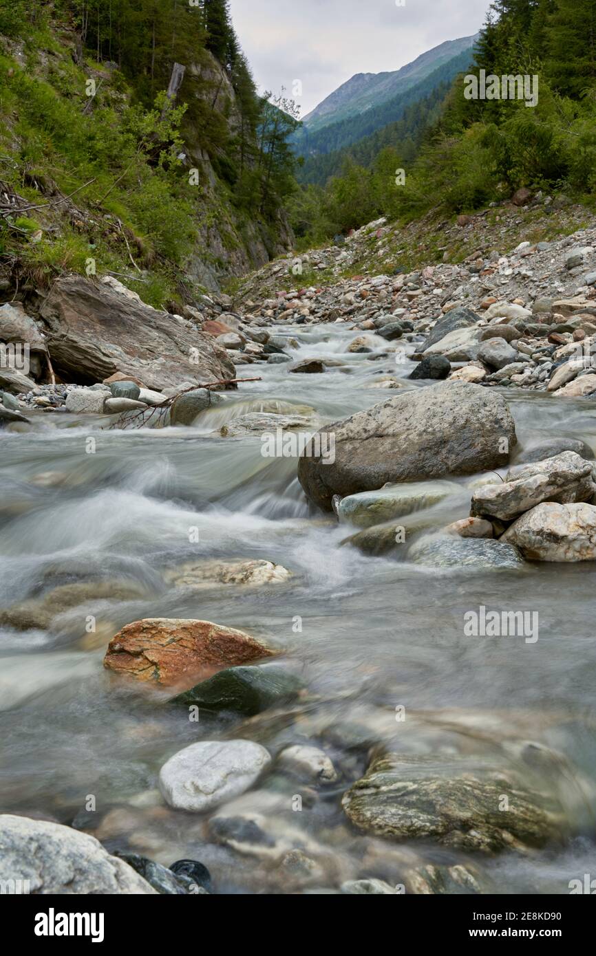 Valley in the alps with river Stock Photo - Alamy