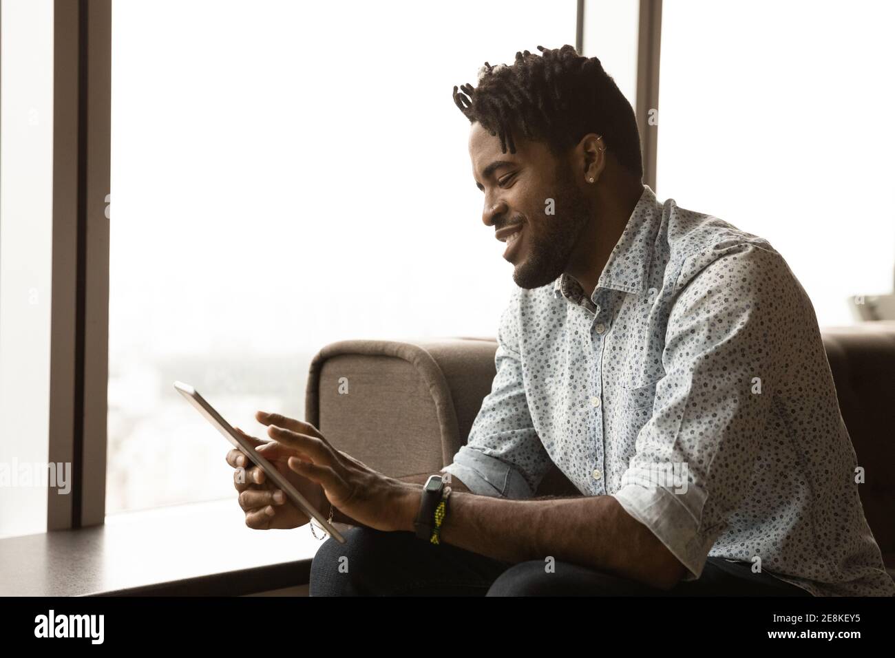 Black hipster guy focused on pad pc screen scrolling menu Stock Photo ...