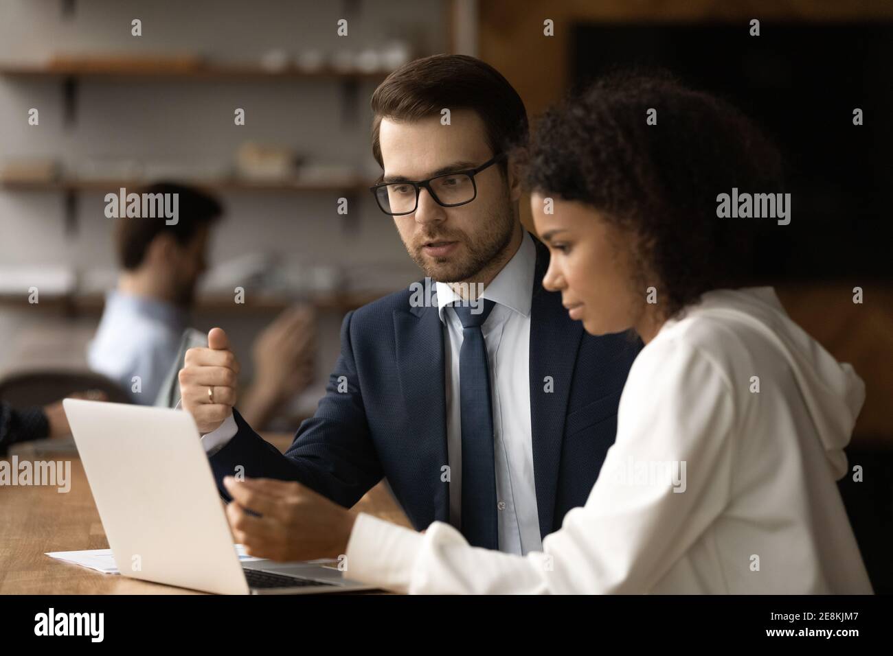 Male expert explain project to african woman client using laptop Stock ...