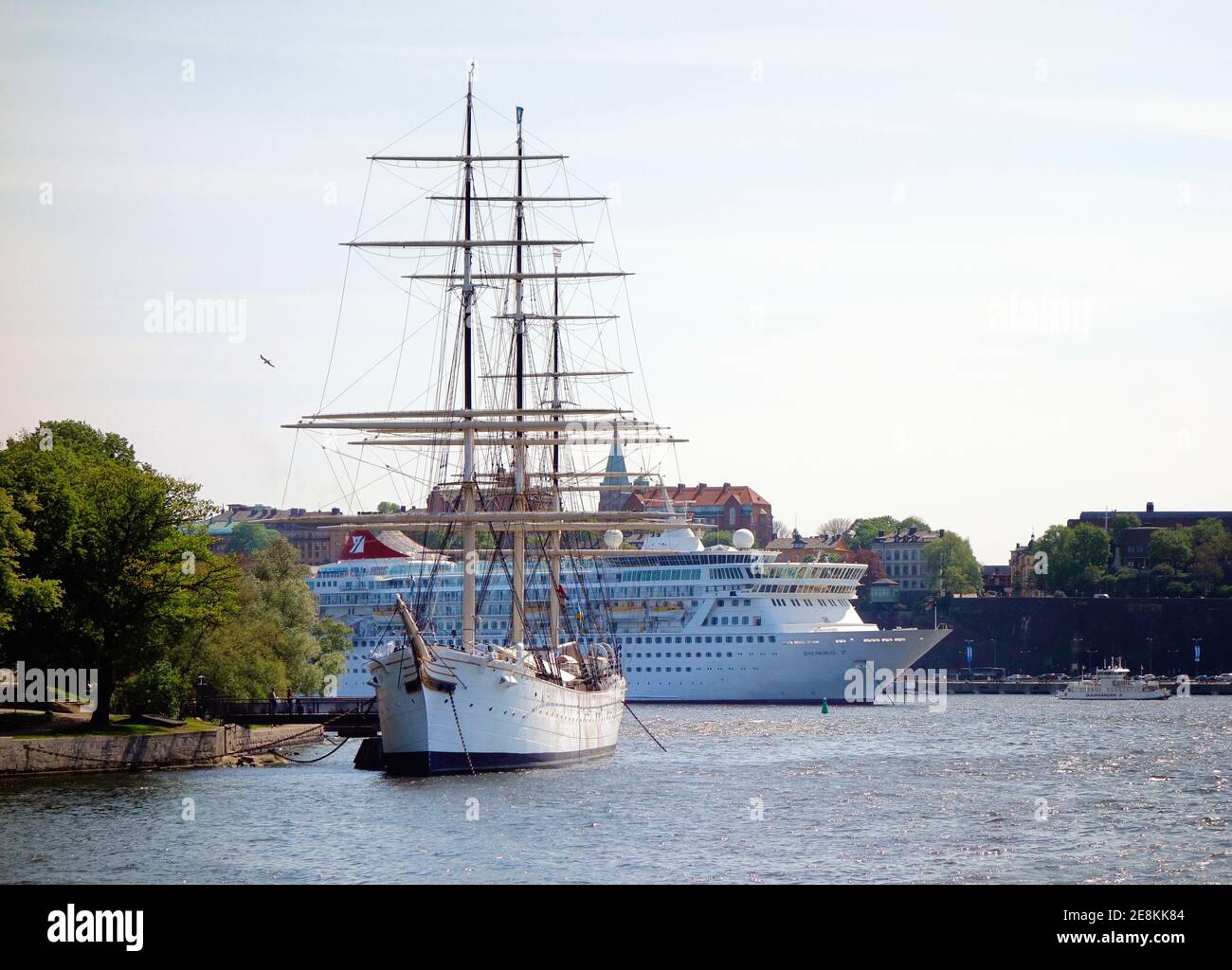 Old sailing ship moored in front of cruise liner in Stockholm Stock ...