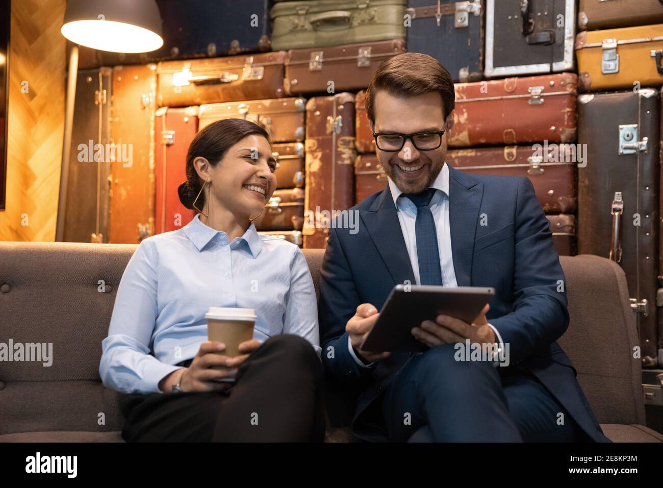Happy colleagues rest on sofa in office at break time Stock Photo - Alamy
