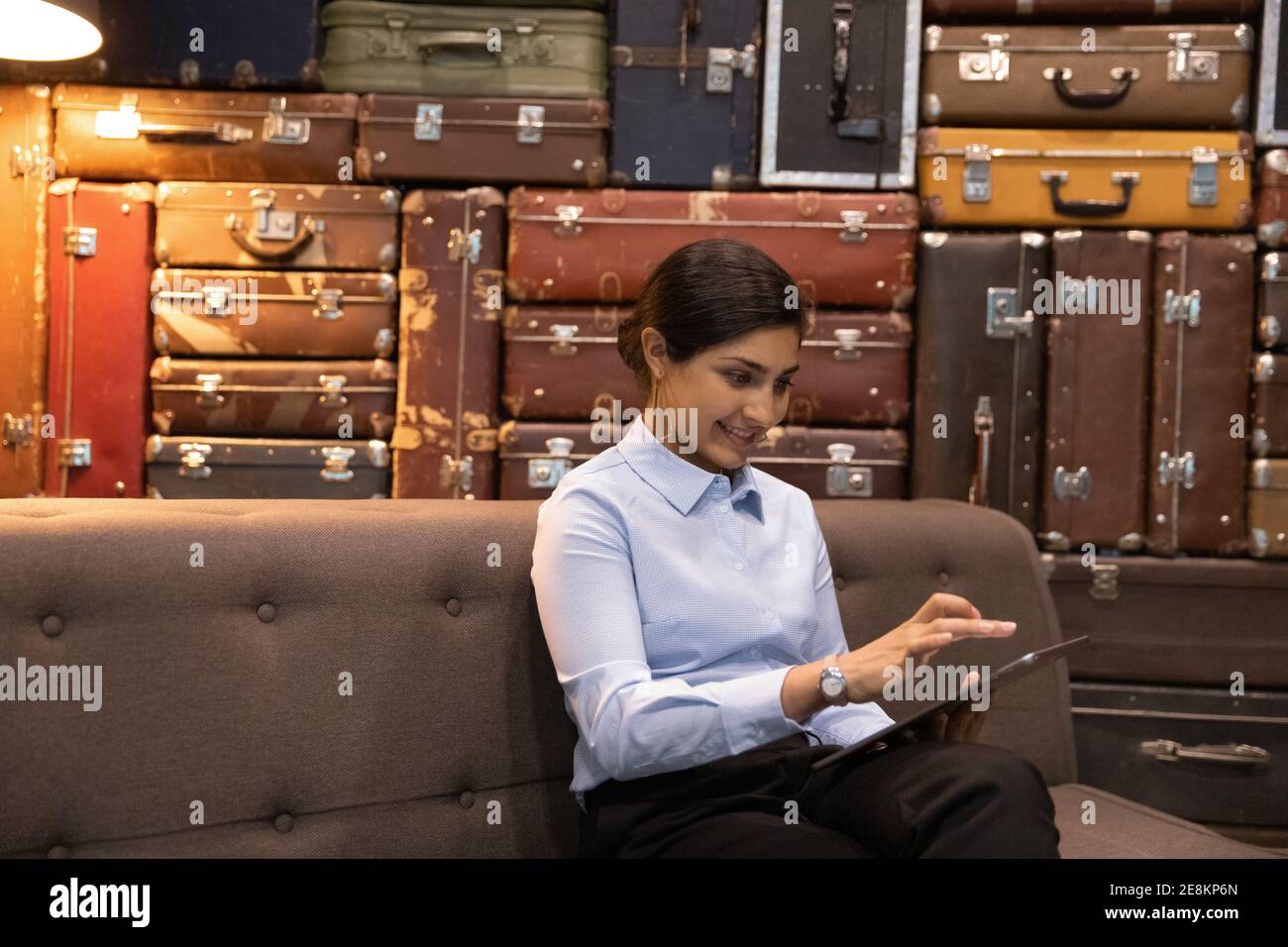 Young indian woman using tablet pc at modern office lounge Stock Photo ...