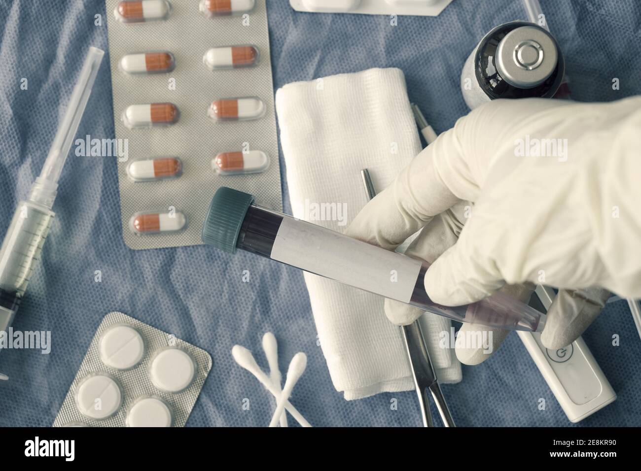 A closeup of a blood te in a doctor's hand on an operating table ...