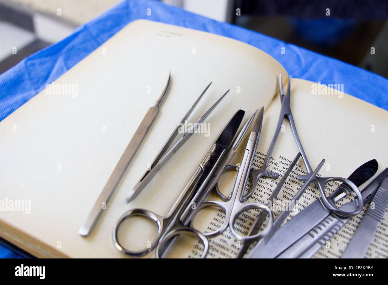 A closeup of a dissection kit on an opened book on the sterile table ...