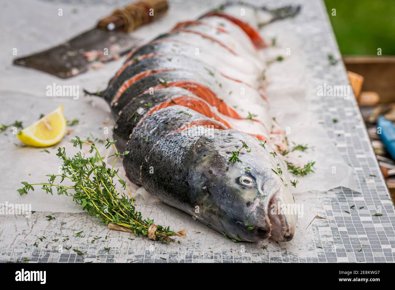 Preparing fresh atlantic salmon with salt and thyme in summer Stock ...